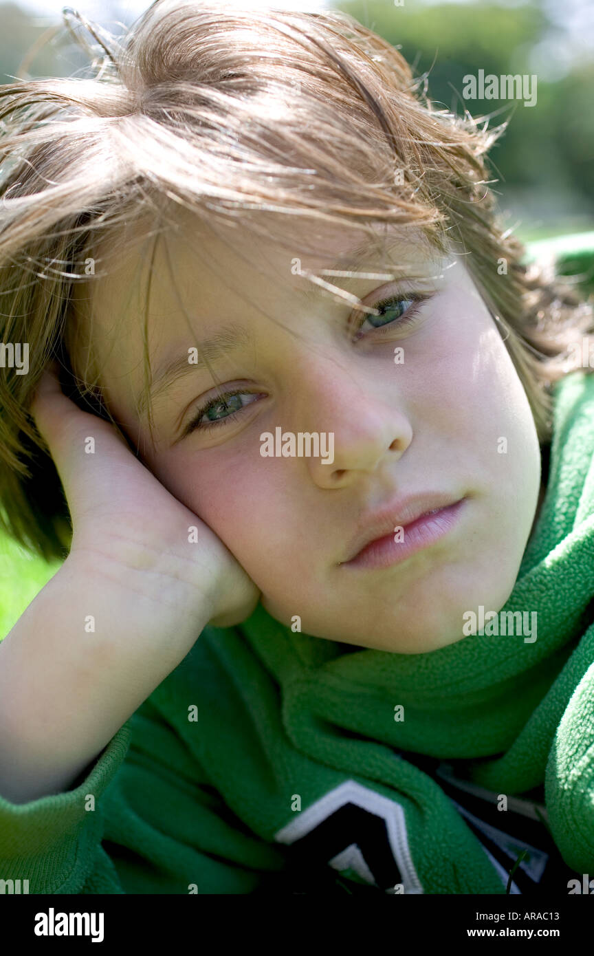 little boy leaning on hand Stock Photo - Alamy