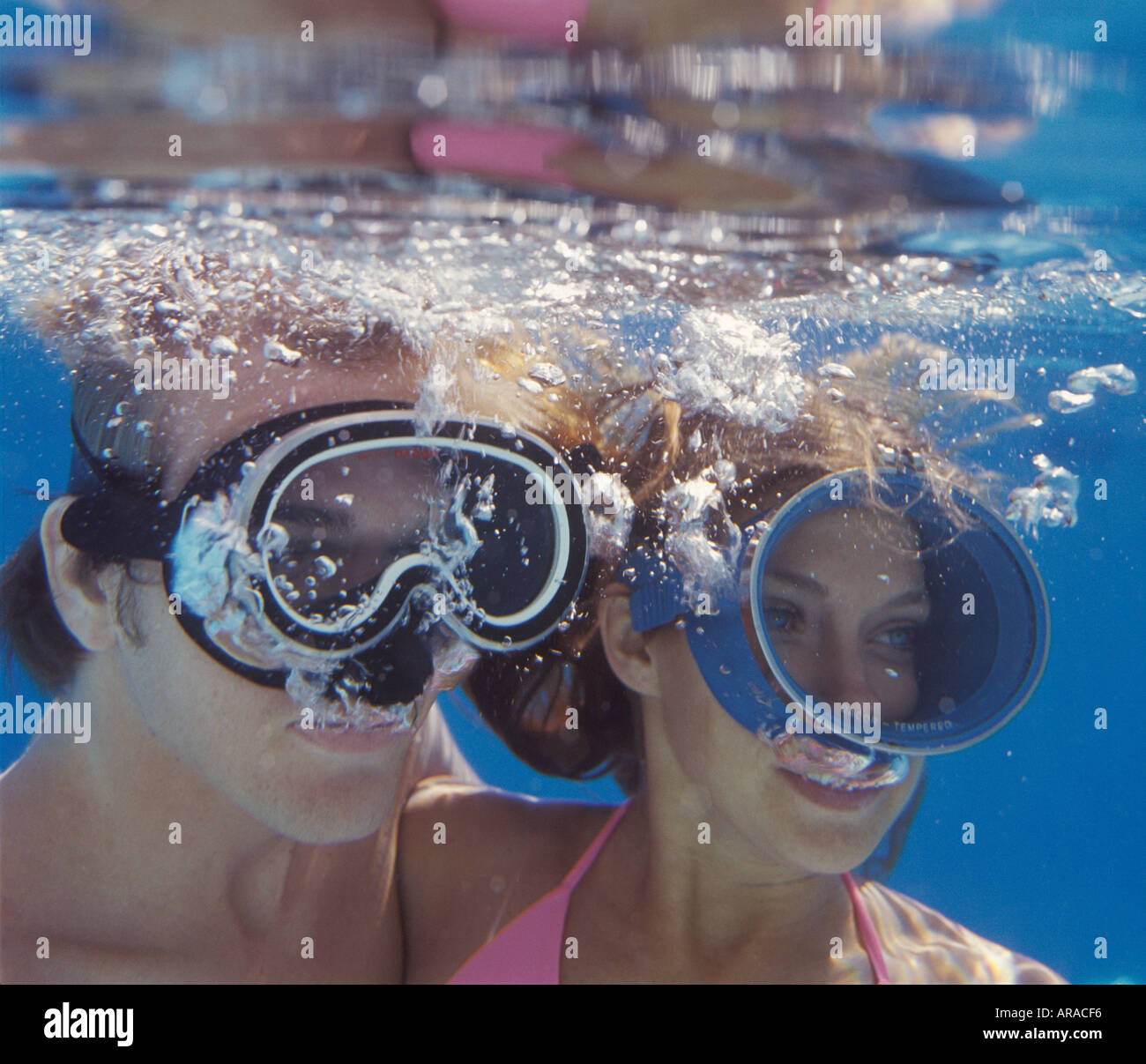 couple skin divers wearing diving masks underwater Stock Photo - Alamy