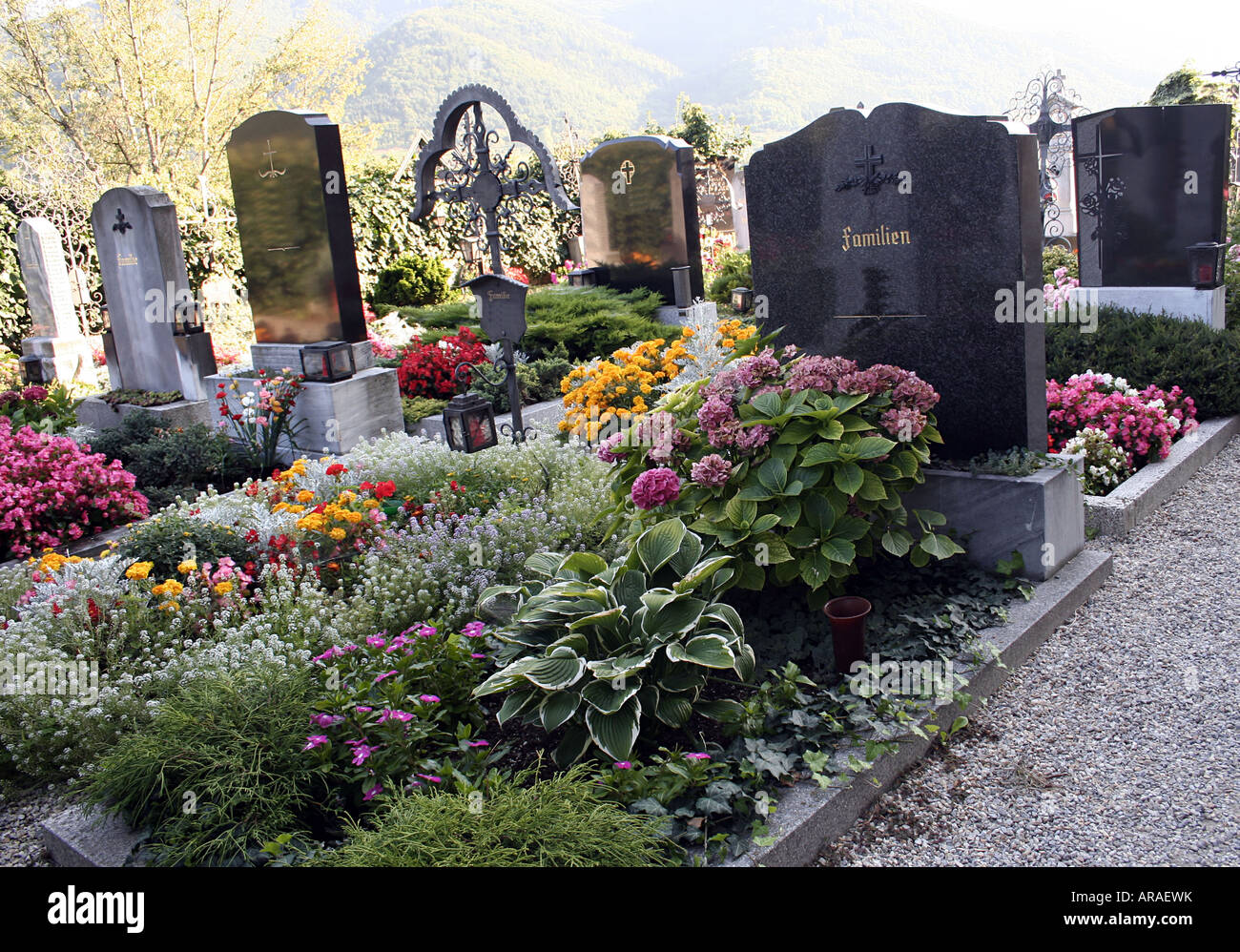 Beautiful catholic graves with many flowers Stock Photo - Alamy