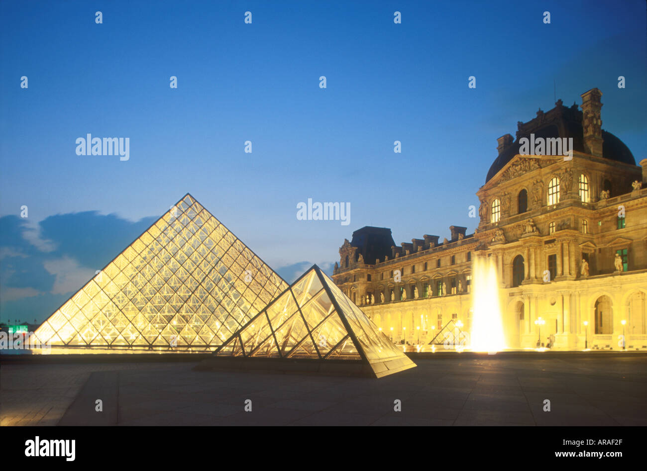 inner courtyard Cour Napoleon enlighted glass Pyramid fountain at night ...