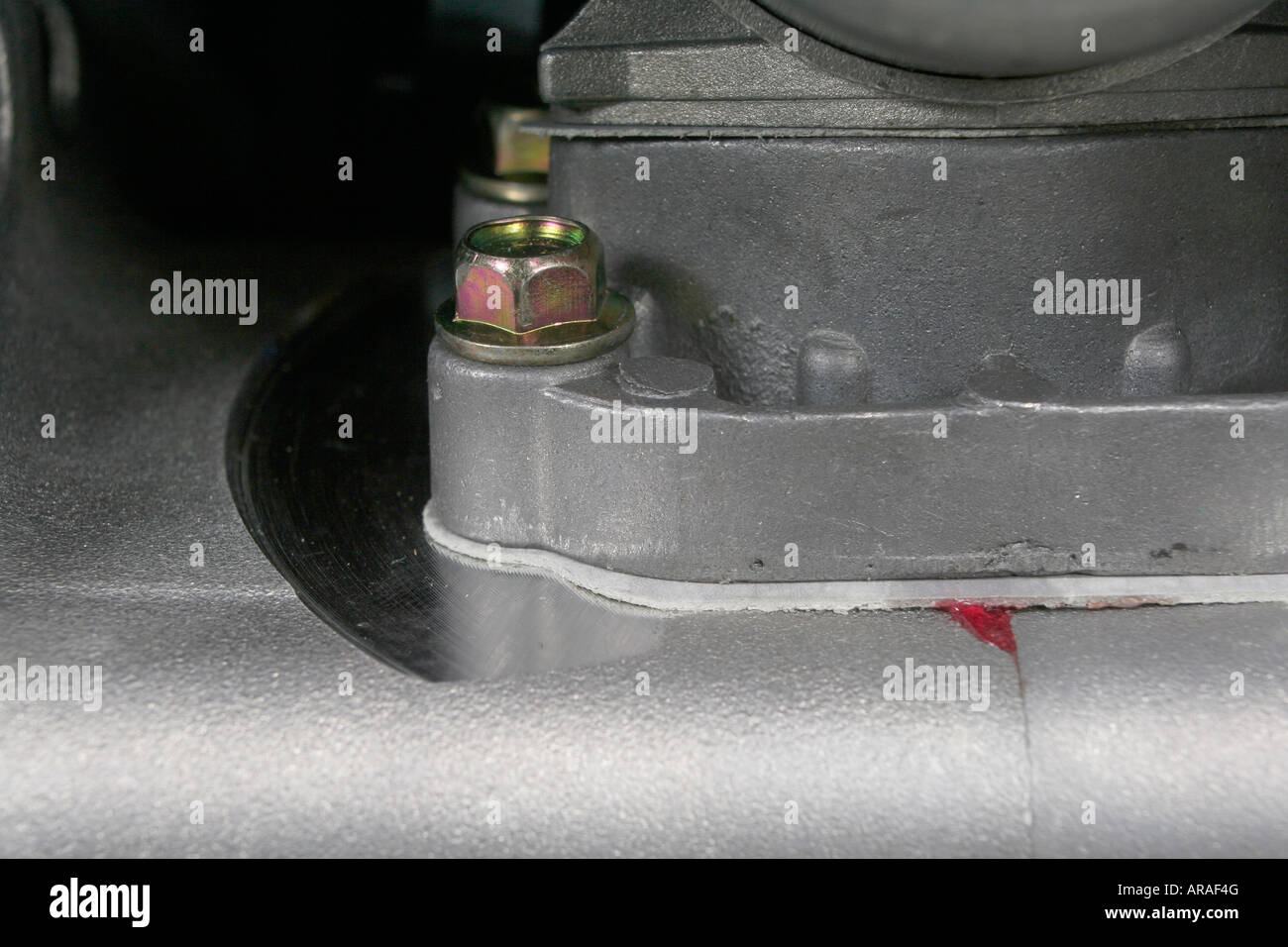 Carburettor mounting plate and valve body on small engine Stock Photo ...