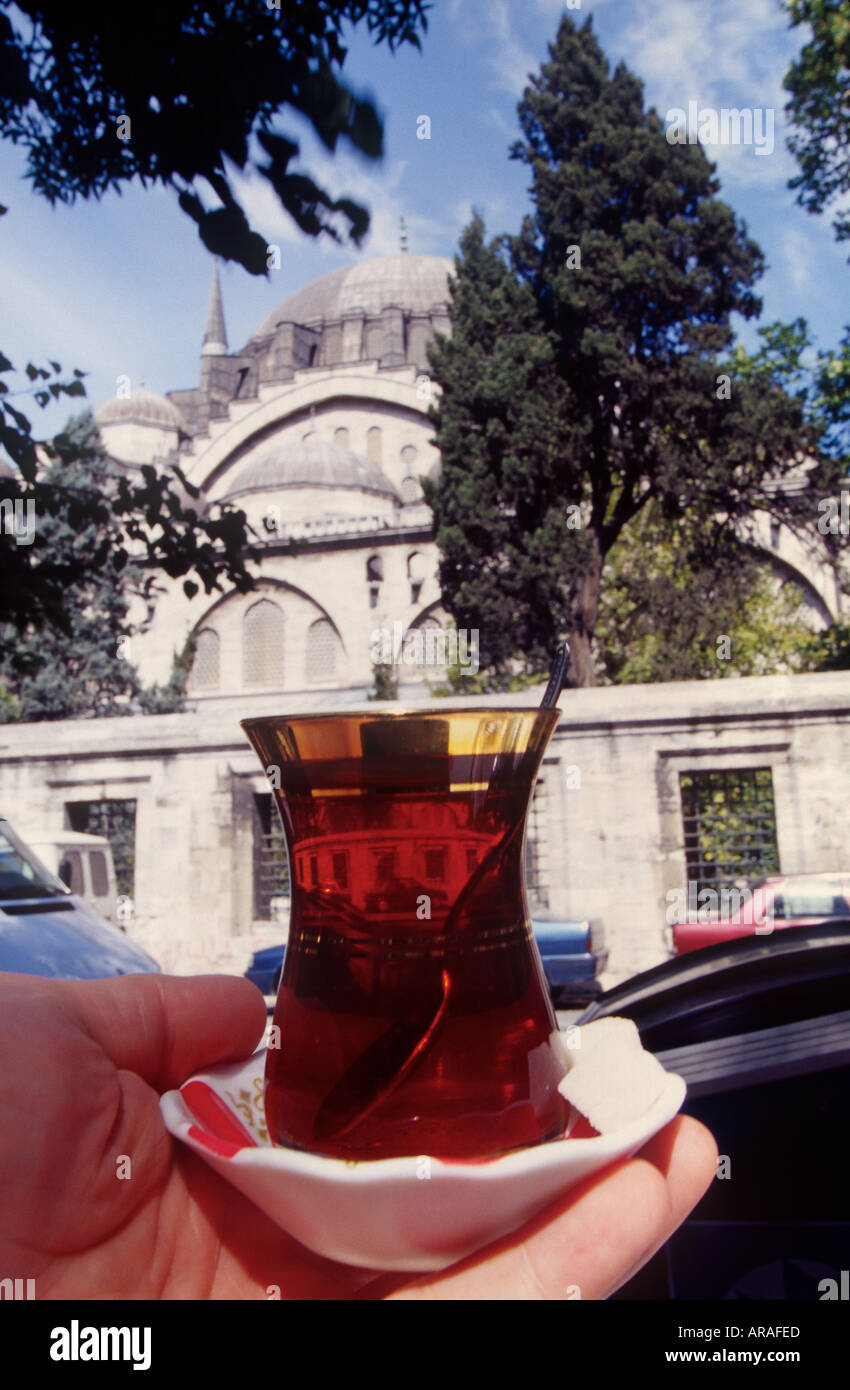 A glass of Turkish tea with Suleymaniye Camii Mosque at the back ...