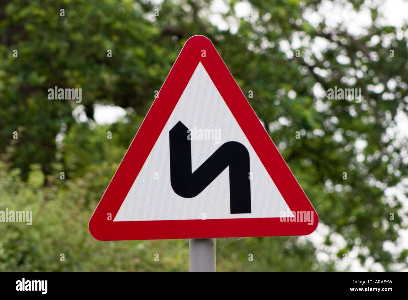Caution bends in road road sign Stock Photo - Alamy