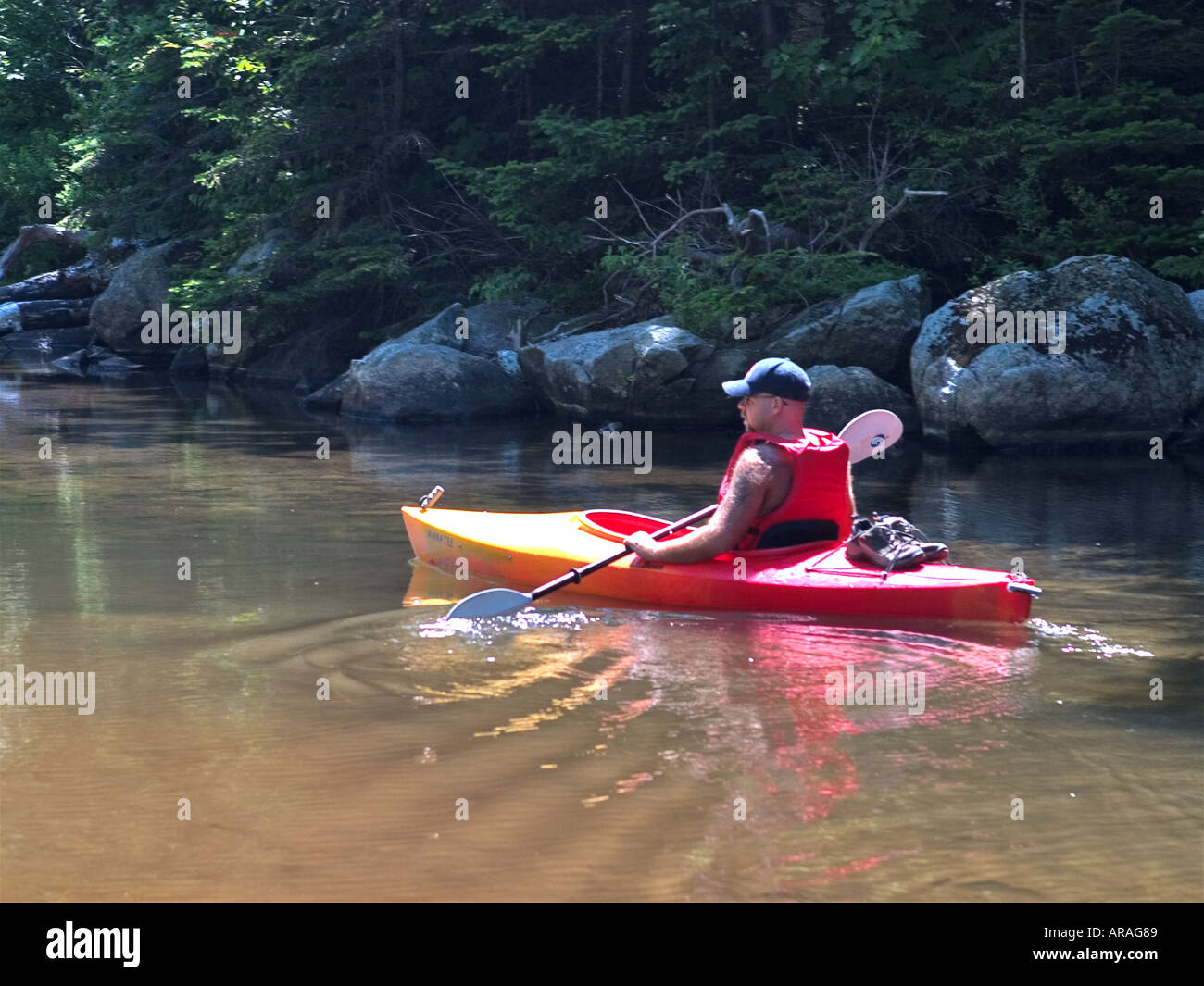 Kayaking on a mountain lake in the White Mountains of New Hampshire ...