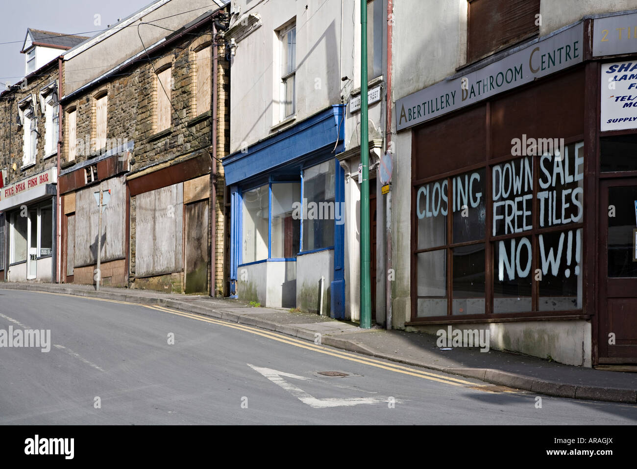 Run down street with boarded up closed shops Abertillery Wales UK Stock ...