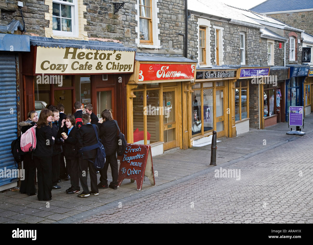 Children in group outsdie fish and chip shop during school lunch break ...