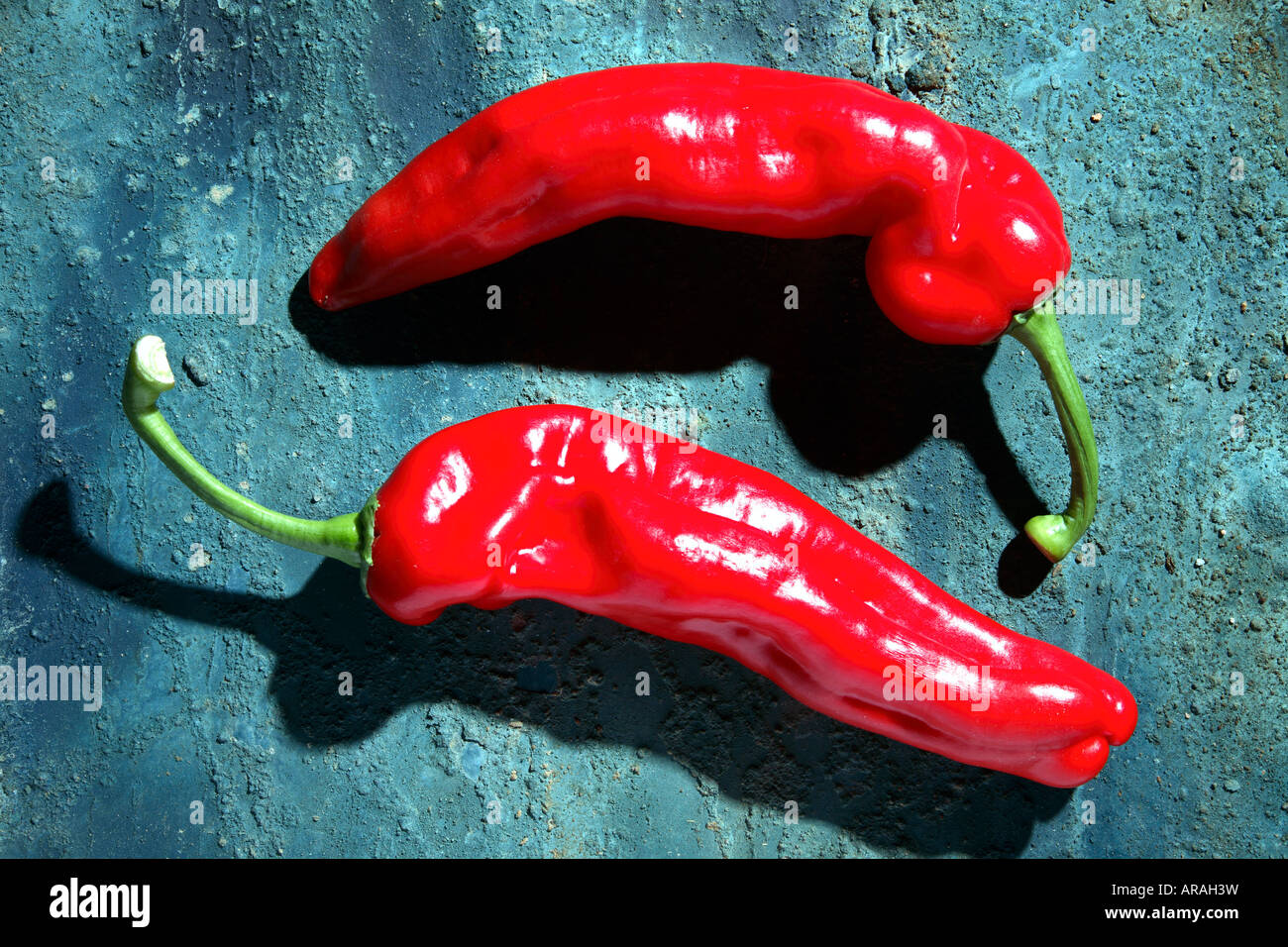 Red Romano Peppers on a rustic blue background Stock Photo - Alamy