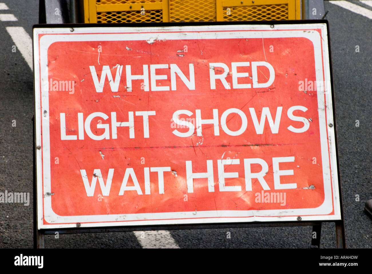 When red light shows wait here road sign Stock Photo - Alamy
