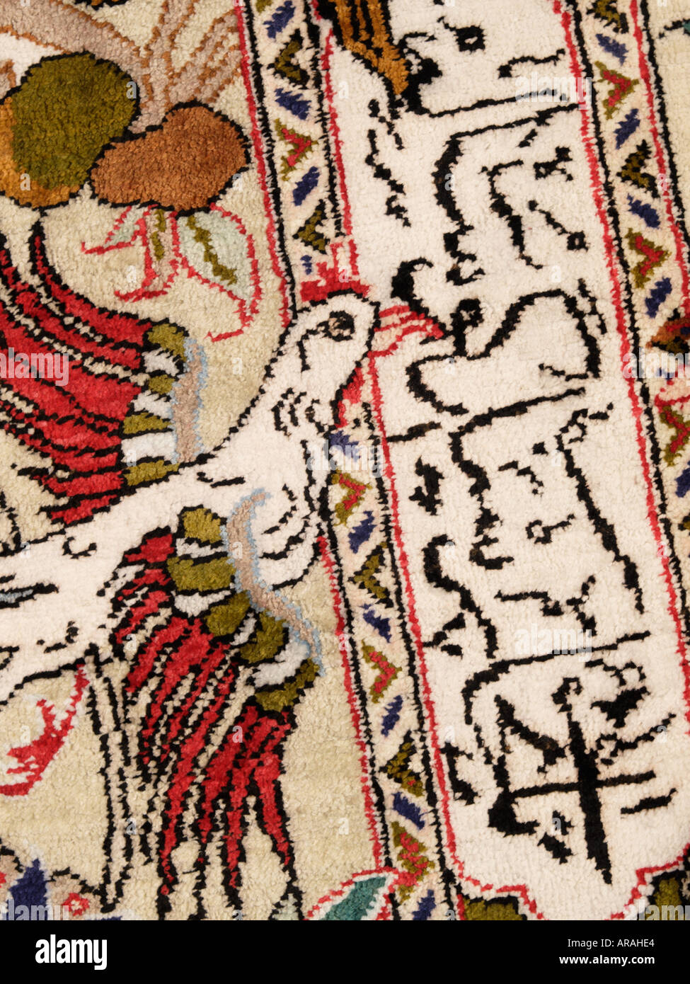 Iranian Persian carpet detail with exotic bird and arabic text words ...
