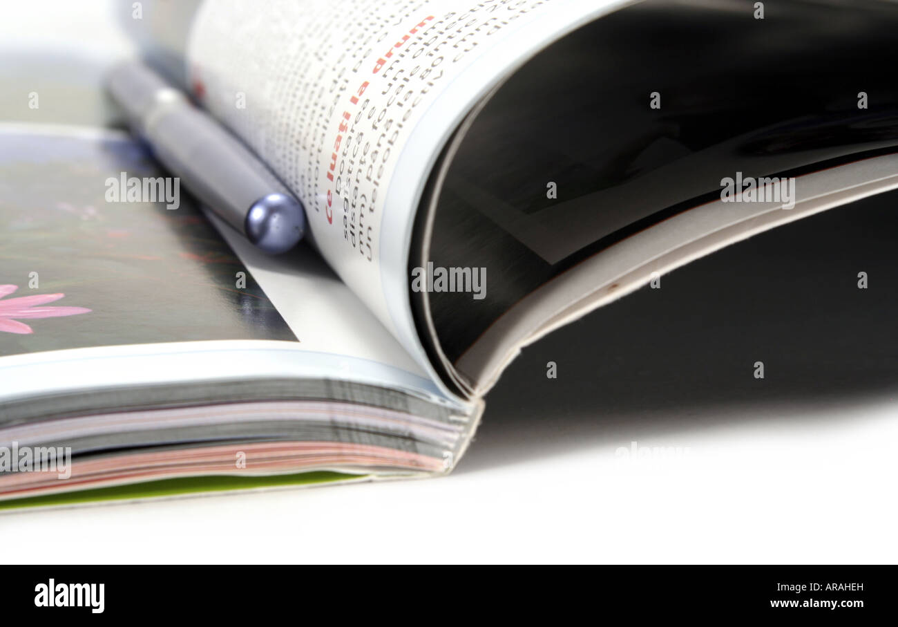 Pen on a book isolated on white Stock Photo - Alamy