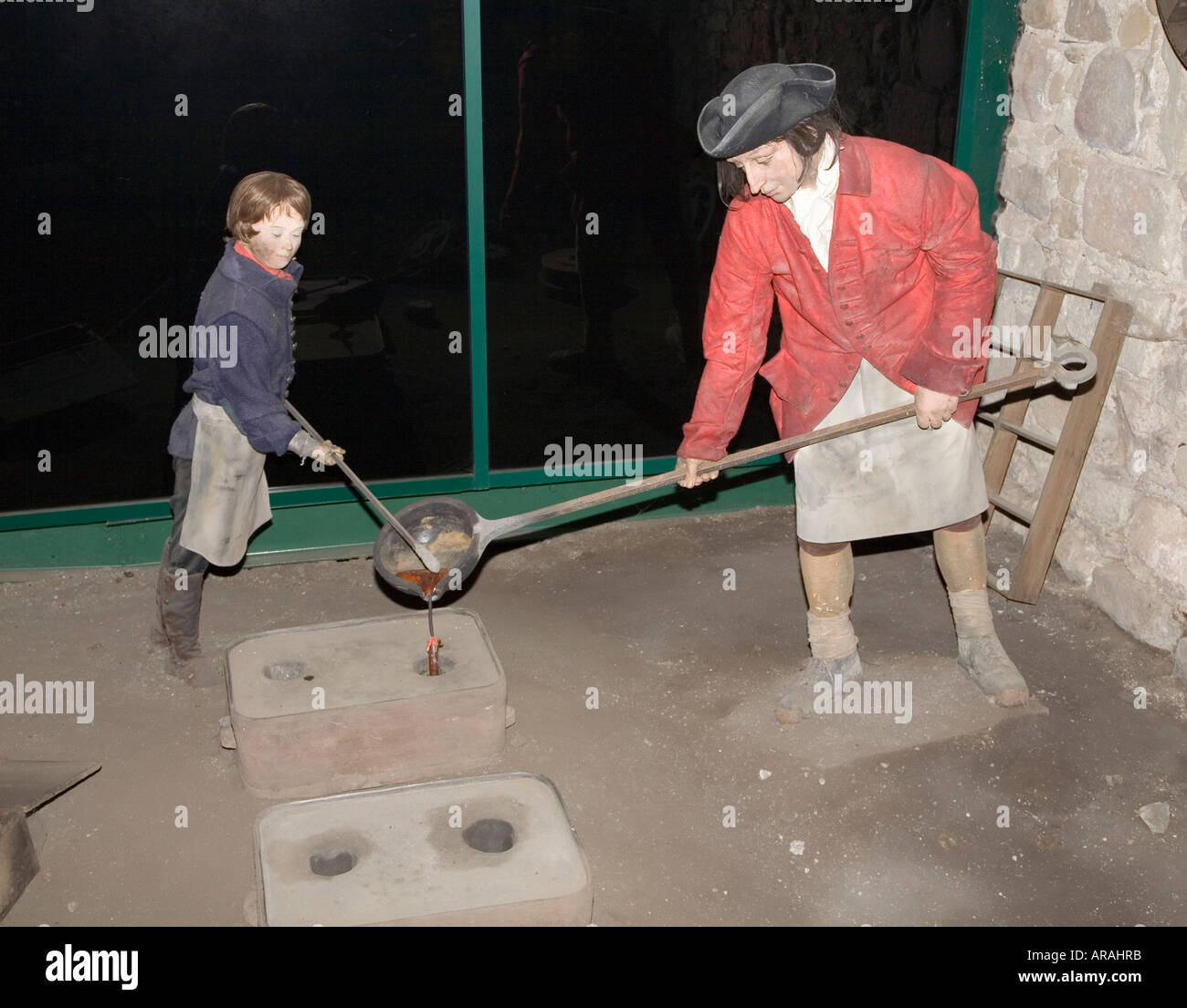 Model of people pouring iron into moulds at Bersham Ironworks Wrexham ...