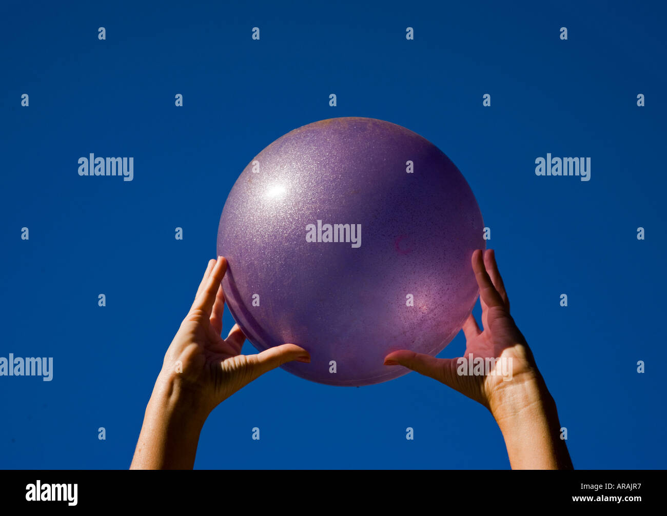 Hands holding a ball Stock Photo - Alamy