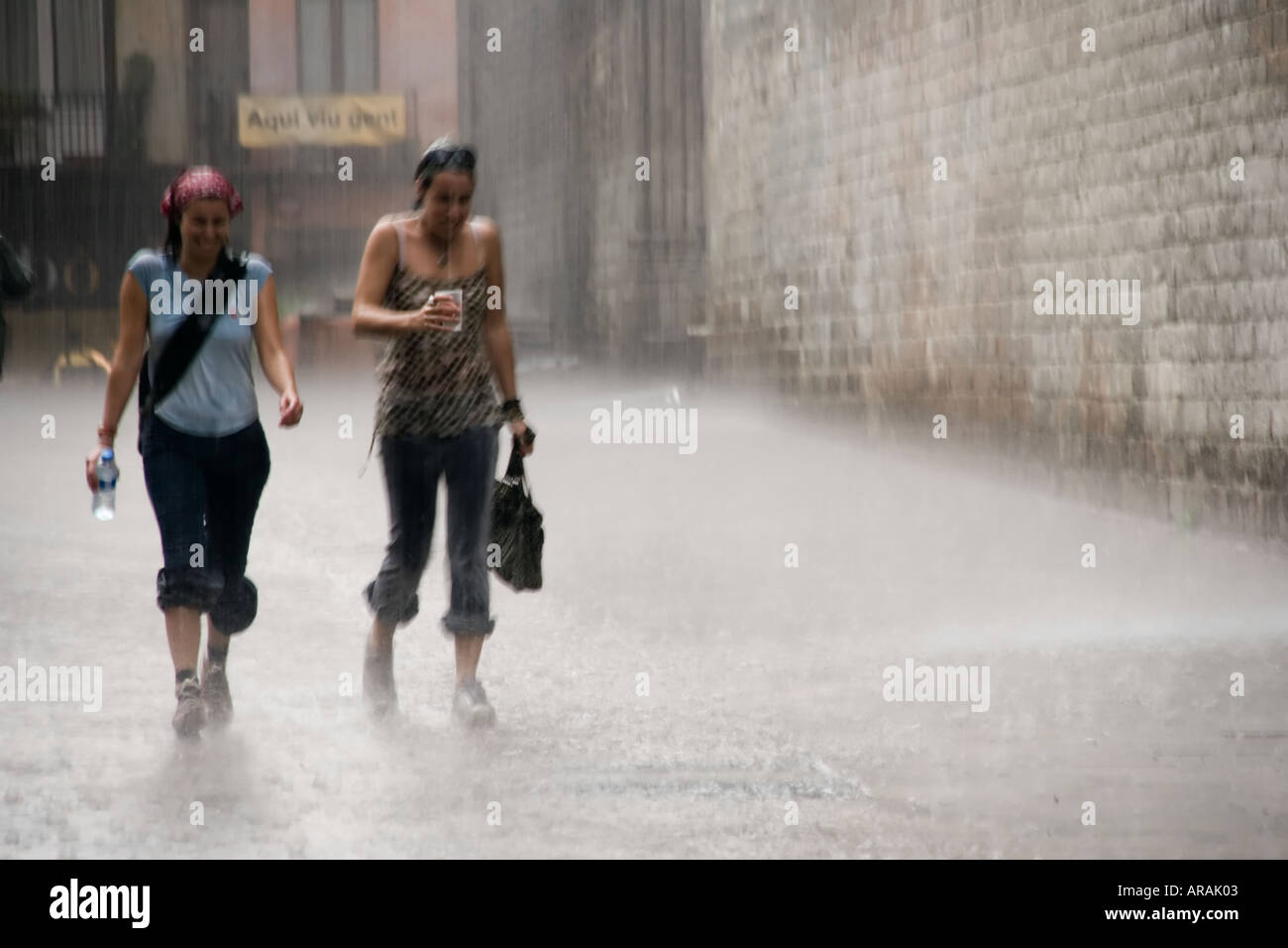 Two young women in rain Stock Photo - Alamy