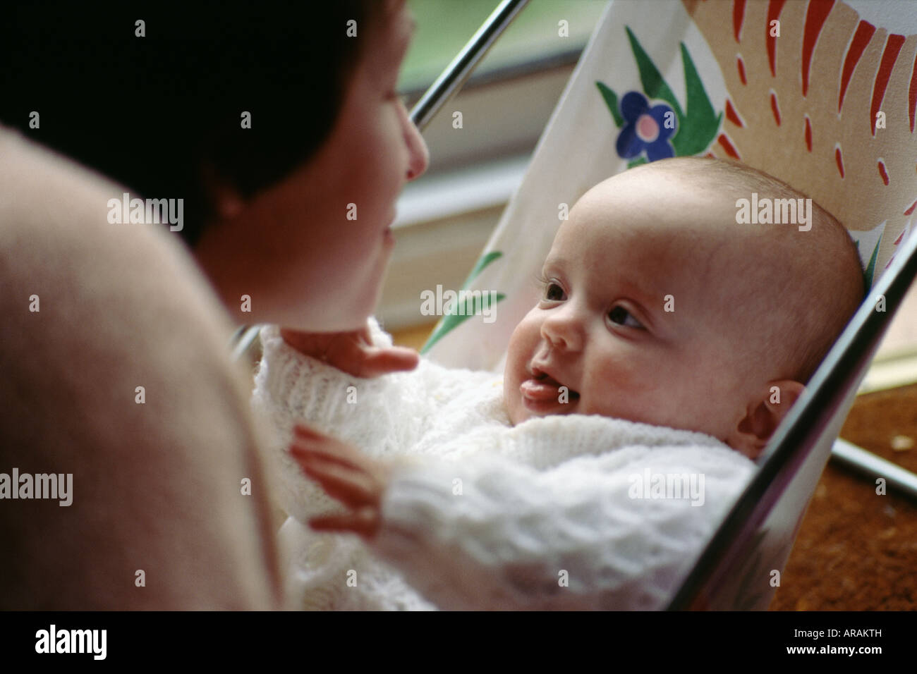 Baby imitating mother and trying to communicate Stock Photo - Alamy