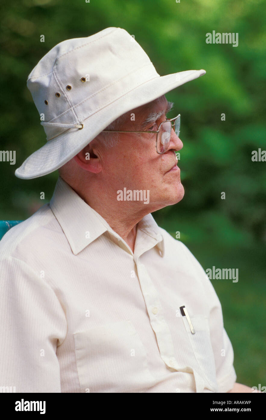Bird watcher green forest background sun hat Stock Photo - Alamy