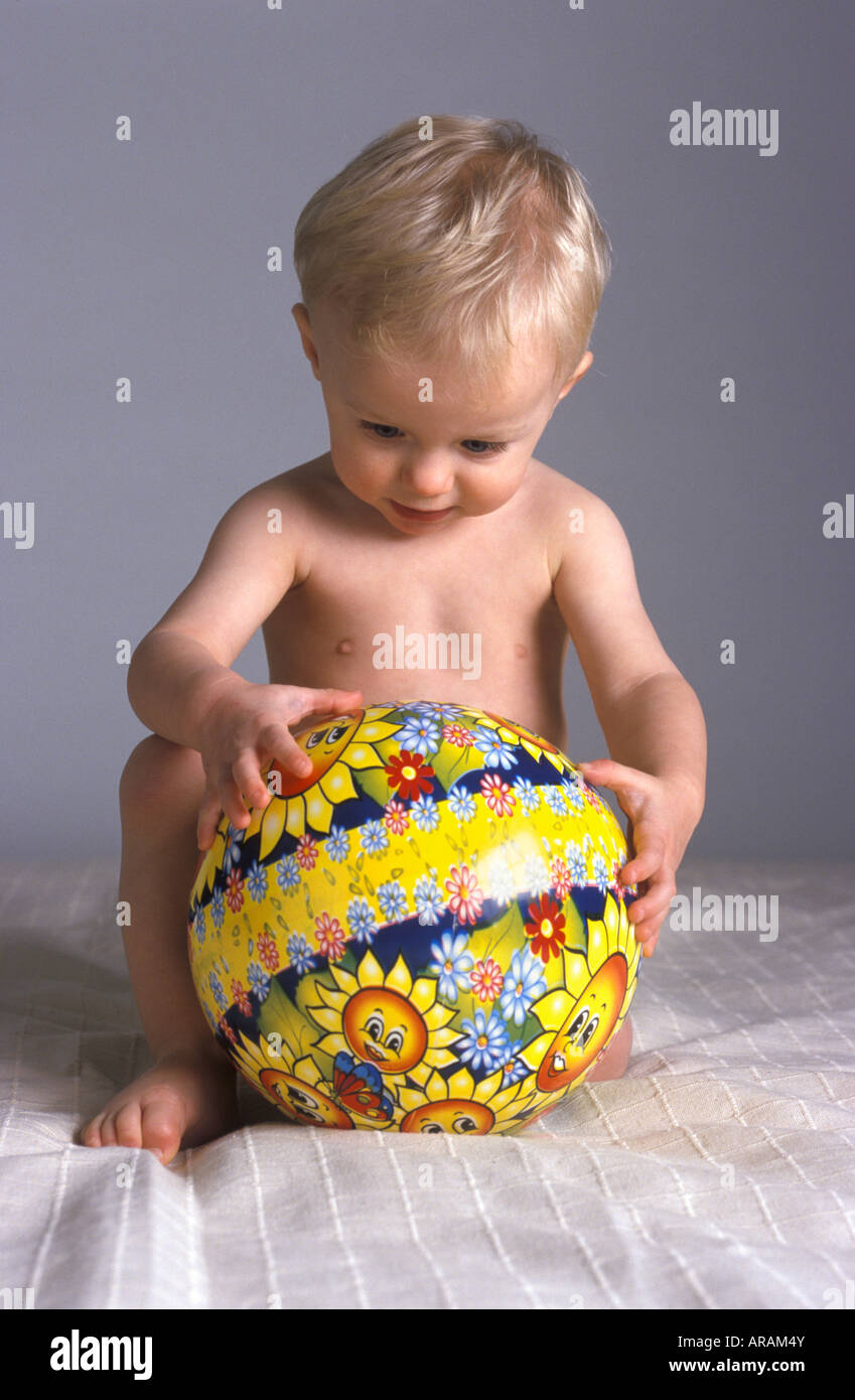Little boy looking at a ball Stock Photo - Alamy