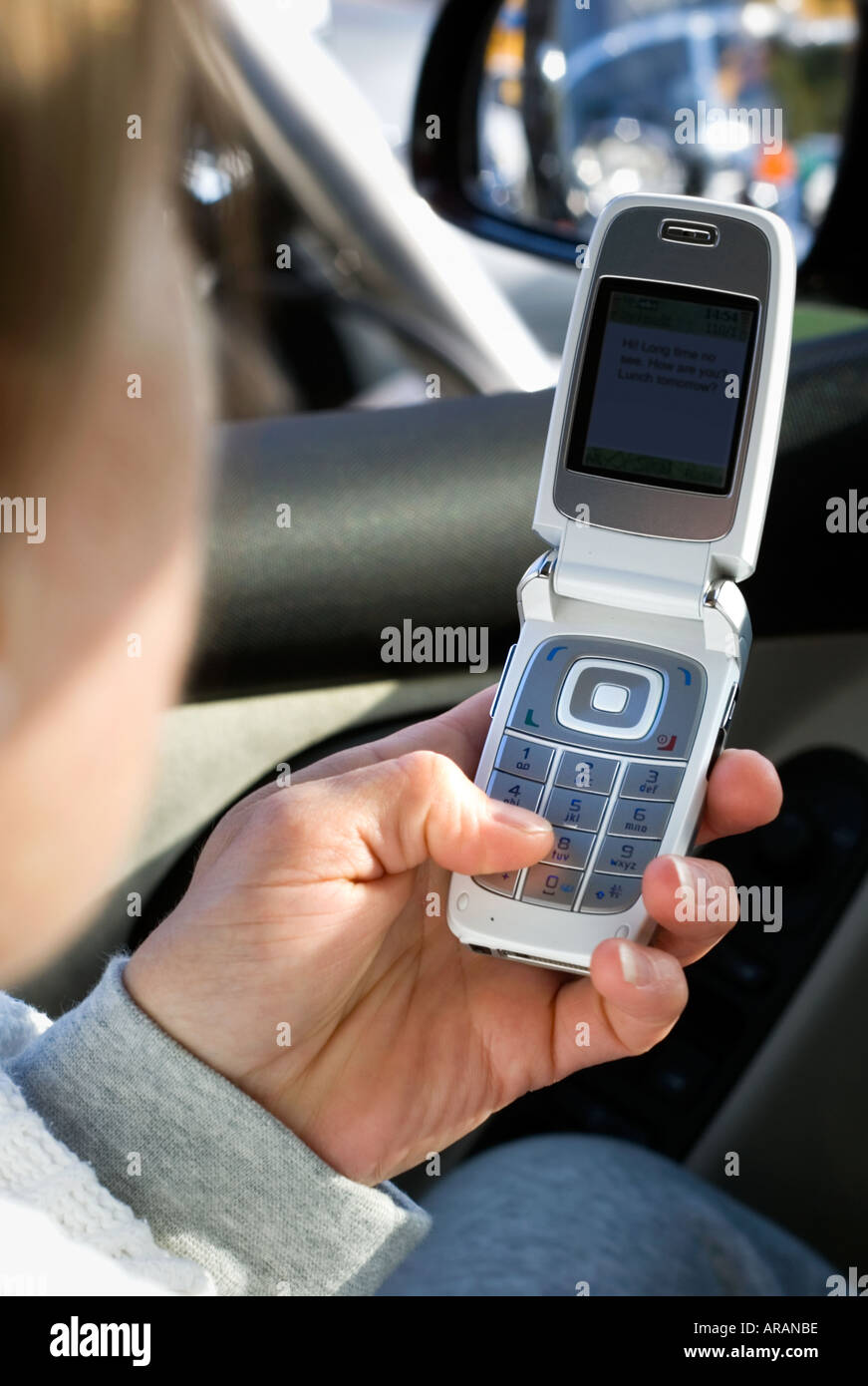 Sending sms with the cell phone model released image Stock Photo - Alamy