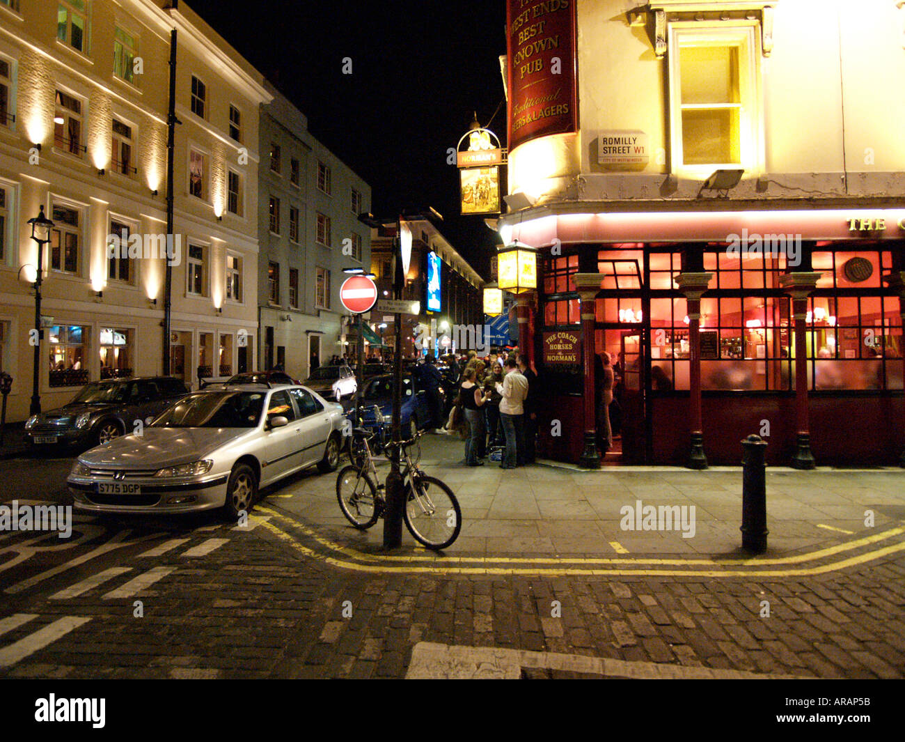 Street scene at night with people outside pub Soho West End London UK ...