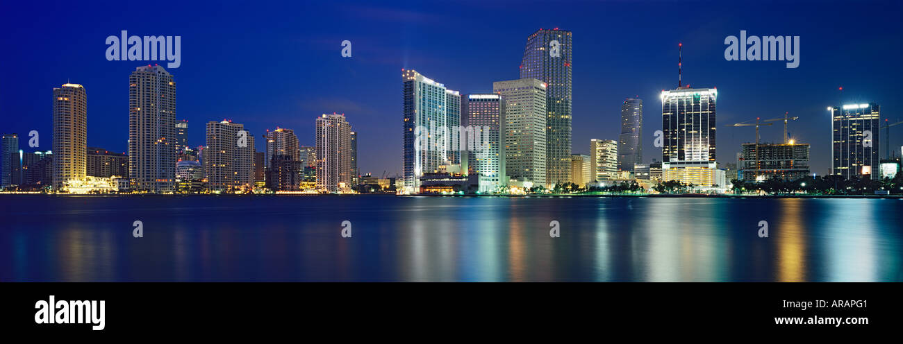 Just before a blue dawn, Biscayne Bay reflects high rise buildings ...