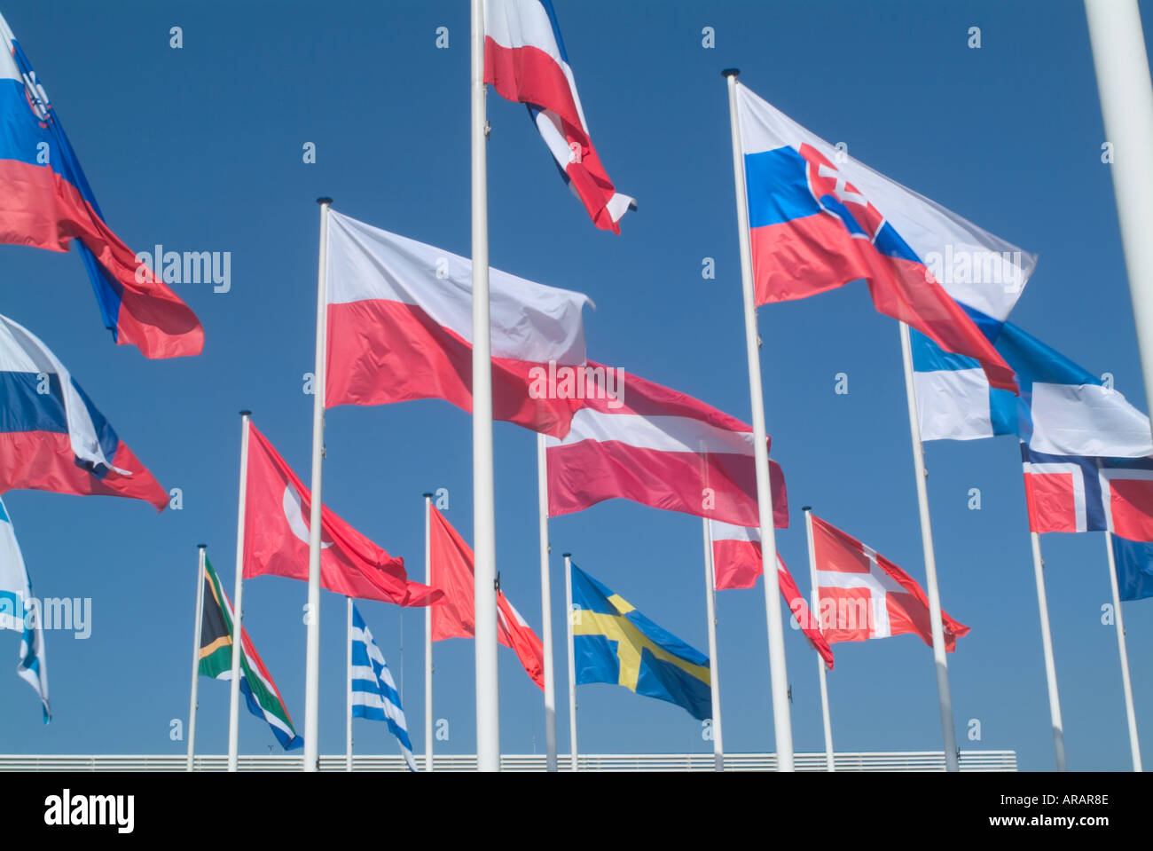 international flags flying against a blue sky Stock Photo - Alamy