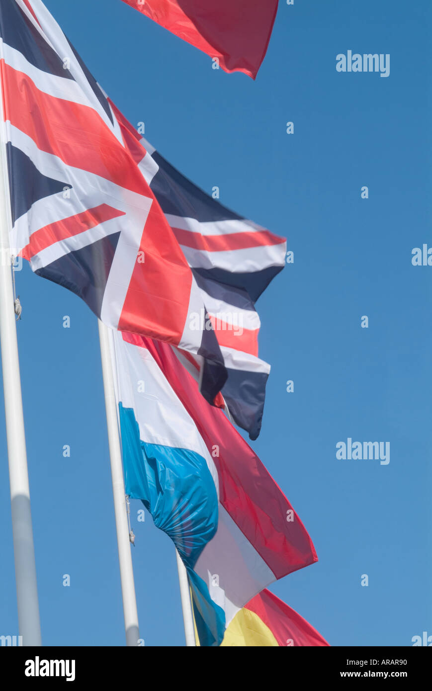 international flags flying against a blue sky Stock Photo - Alamy