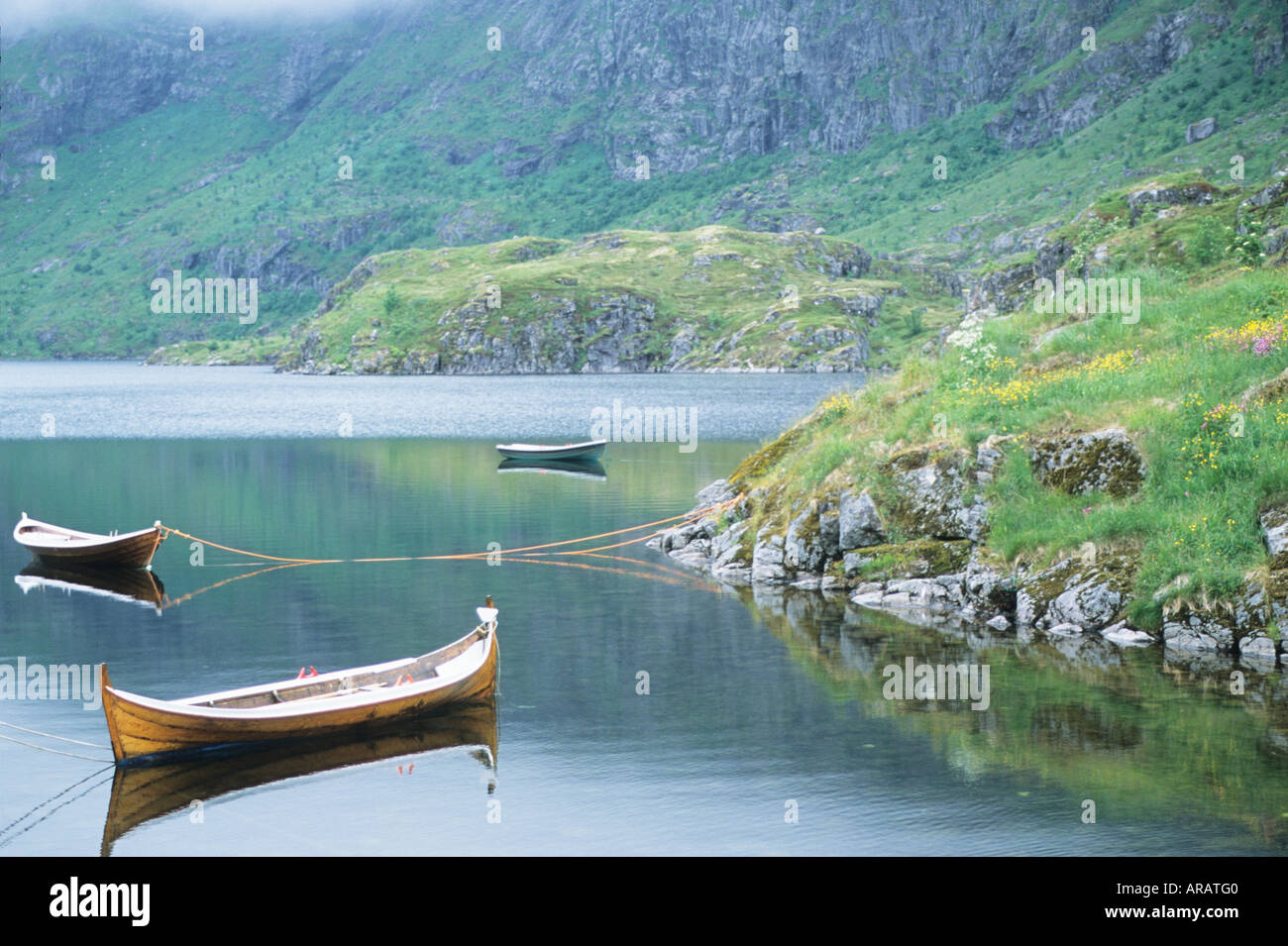 Reflection of wooden row boats in Ågvatnet lake, Å I Lofoten, Lofoten ...