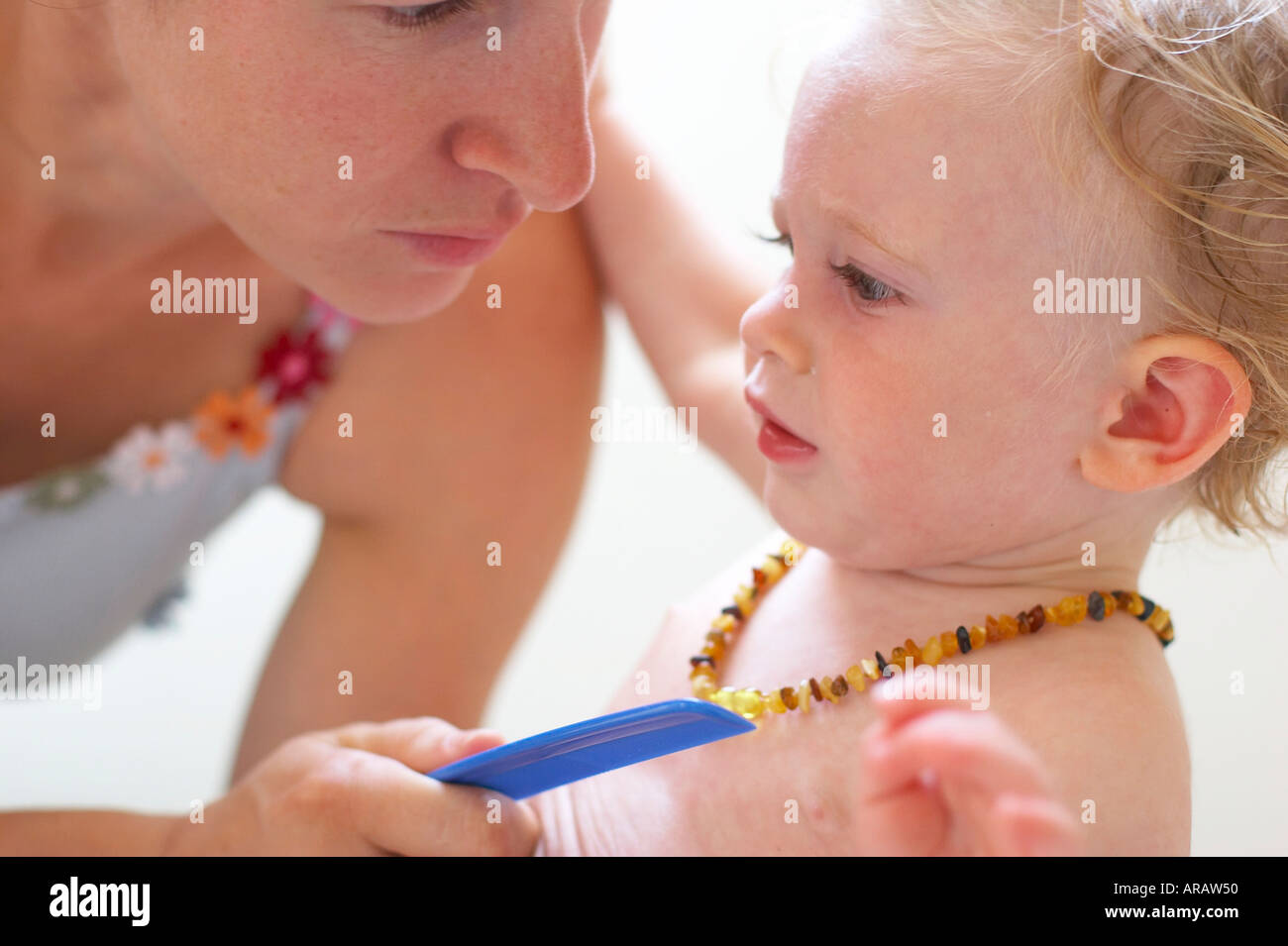 mother combing her baby Stock Photo - Alamy