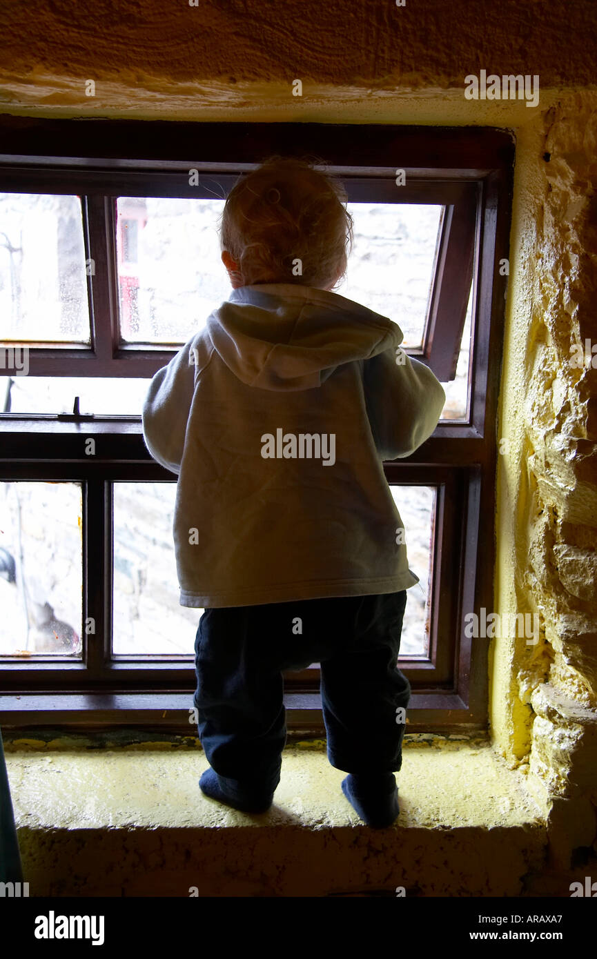 baby standing in window Stock Photo - Alamy