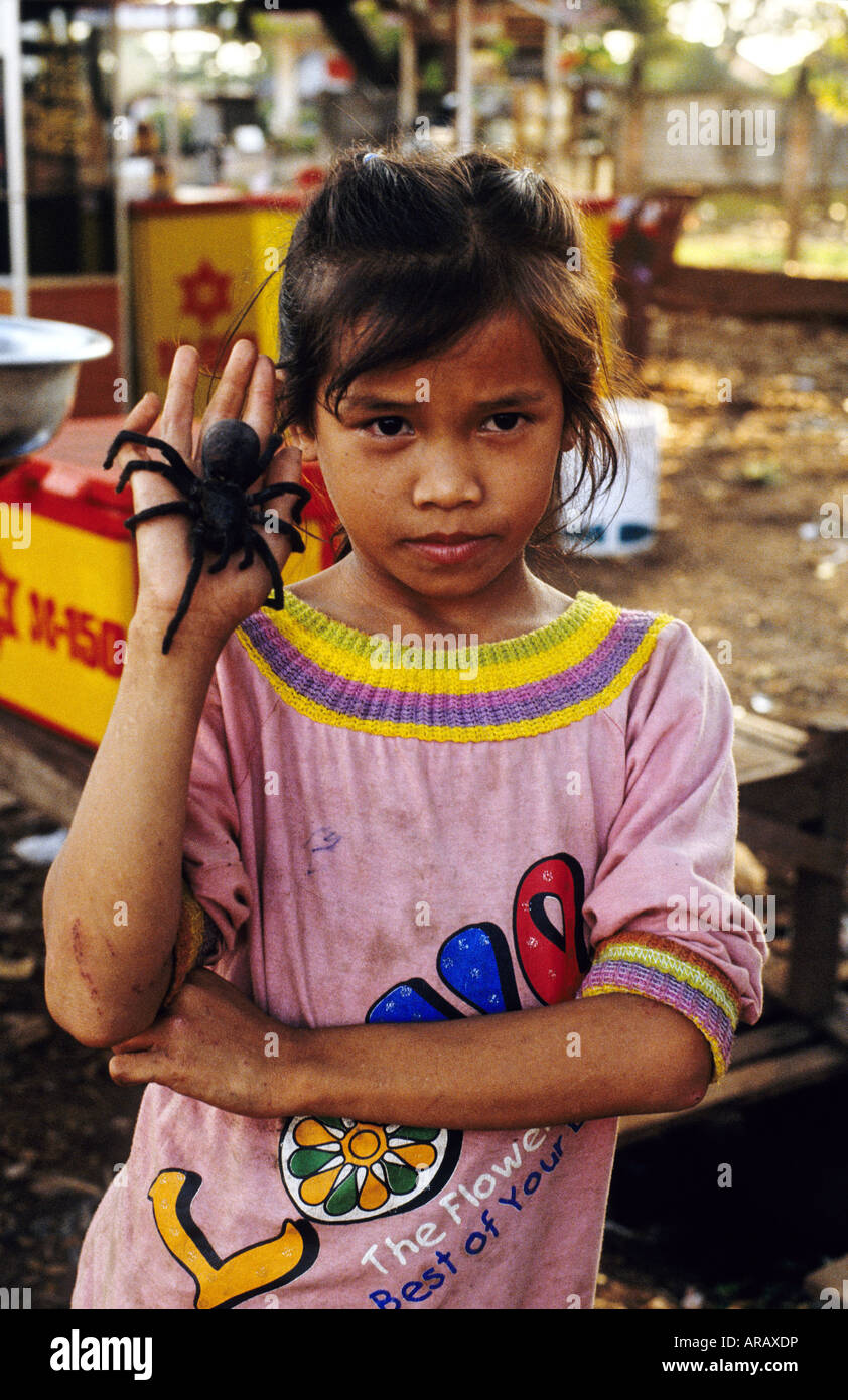Girl with edible 'pet' spider, Skuon (Spiderville), Cambodia Stock ...