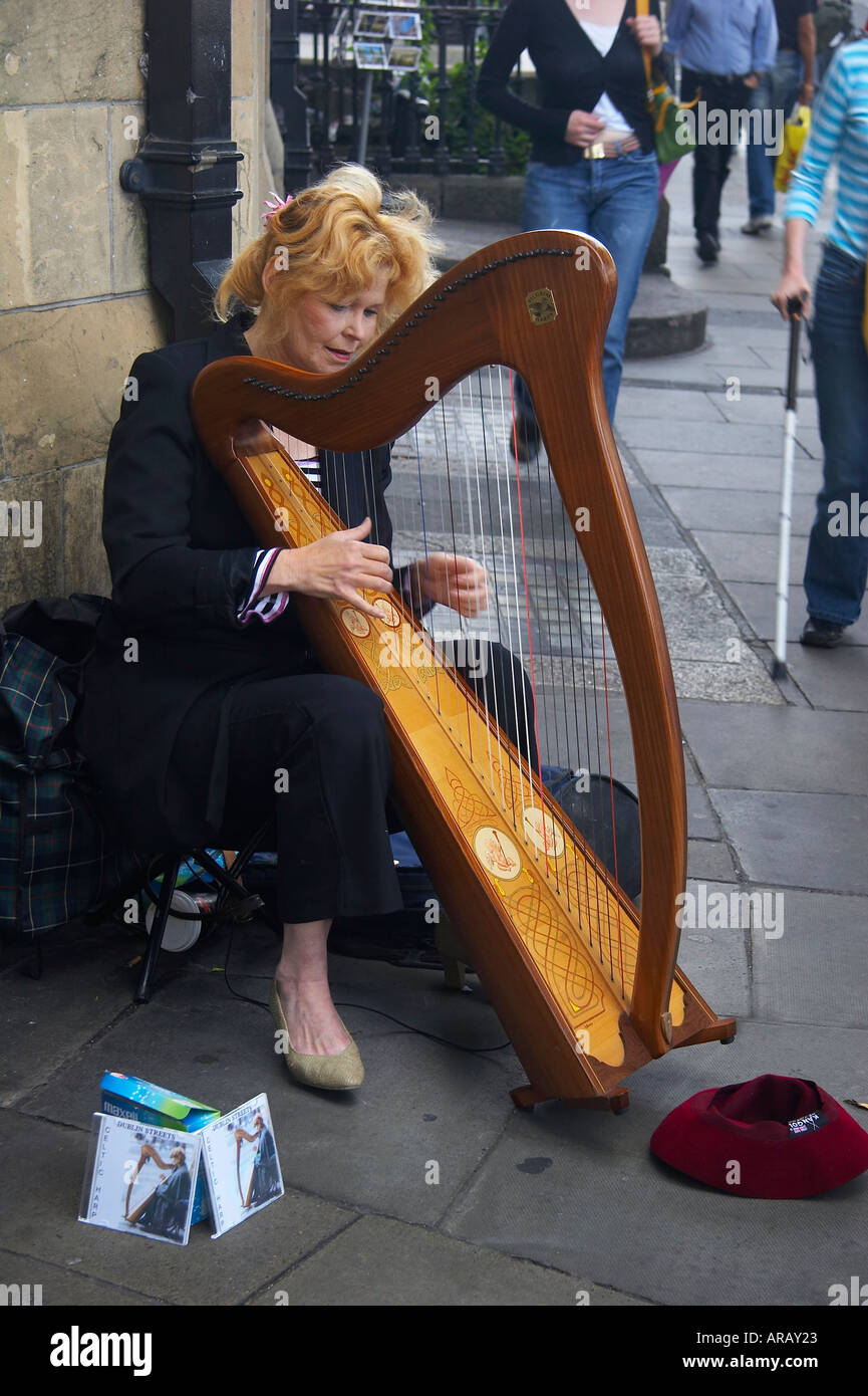 street artist playing on harp Stock Photo - Alamy