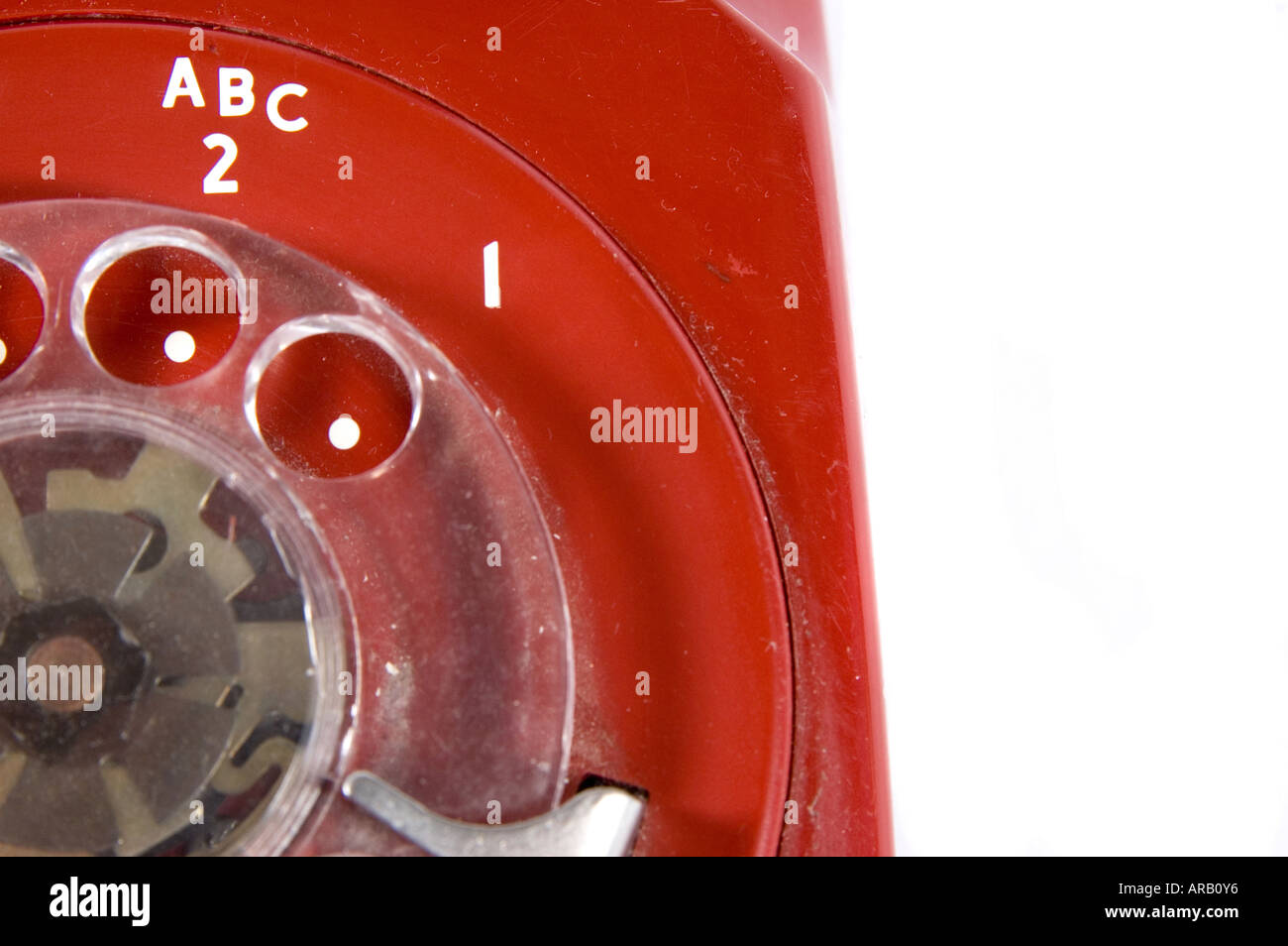 close-up image of the numbers 1 and 2 on a red rotary dial telephone ...