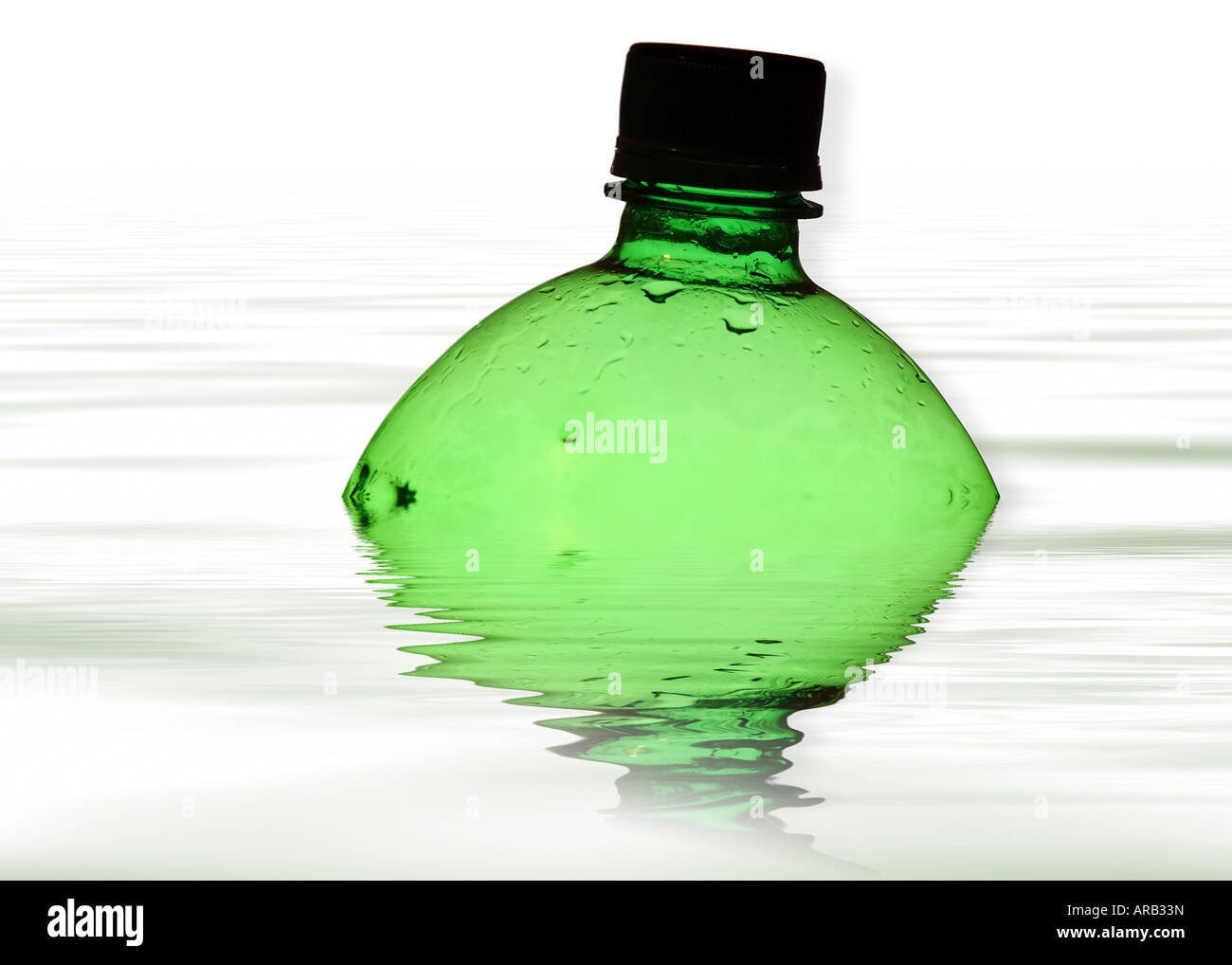 Green bottle floating in water Stock Photo - Alamy