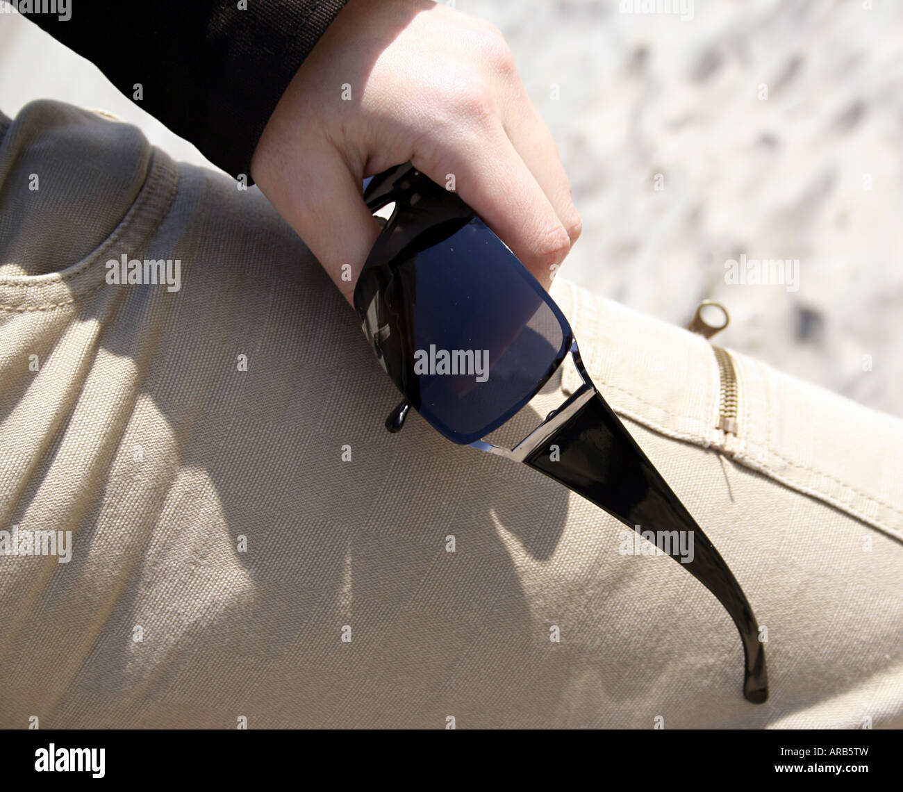 Sunglasses in a girls hand Stock Photo - Alamy