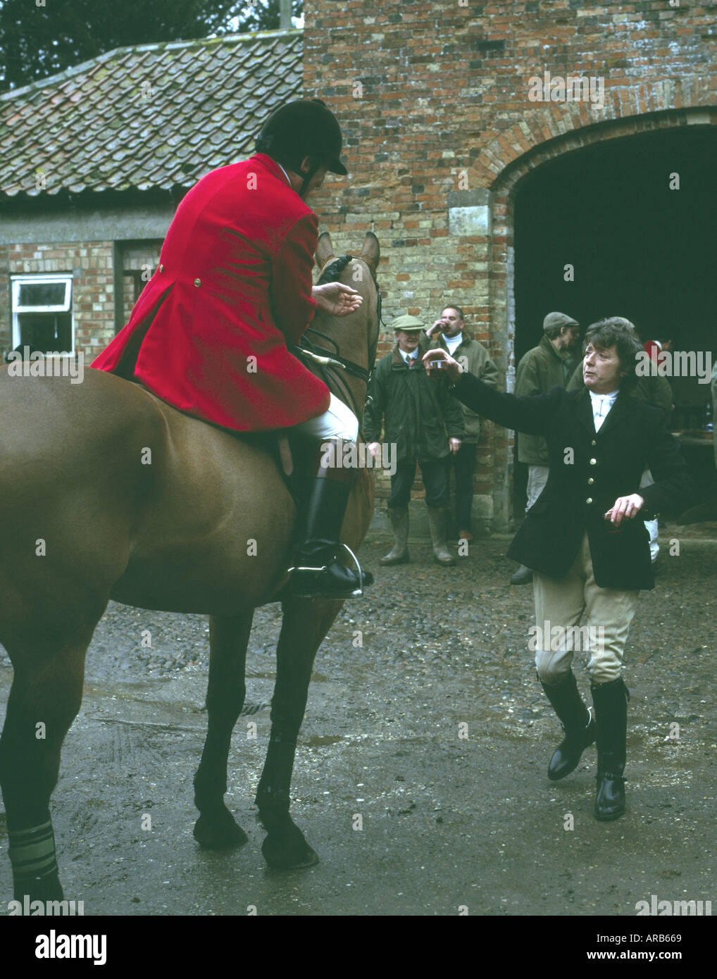 Accepting a traditional 'Stirrup cup' before the start of the hunt in ...