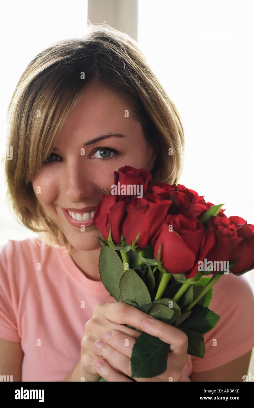 Portrait woman smelling red rose hi-res stock photography and images ...