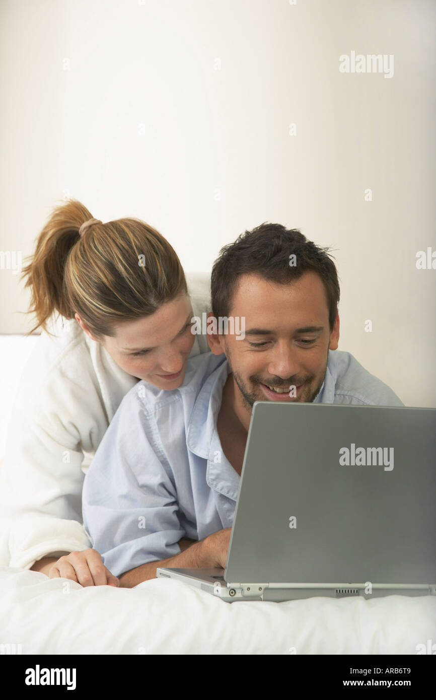 Man woman home bedroom laptop lie bed hi-res stock photography and ...