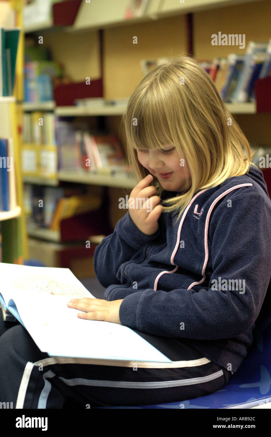young girl reading books in library Stock Photo - Alamy