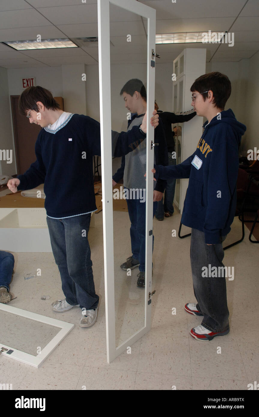 Volunteers construct bookcases for a children s library in a homeless ...