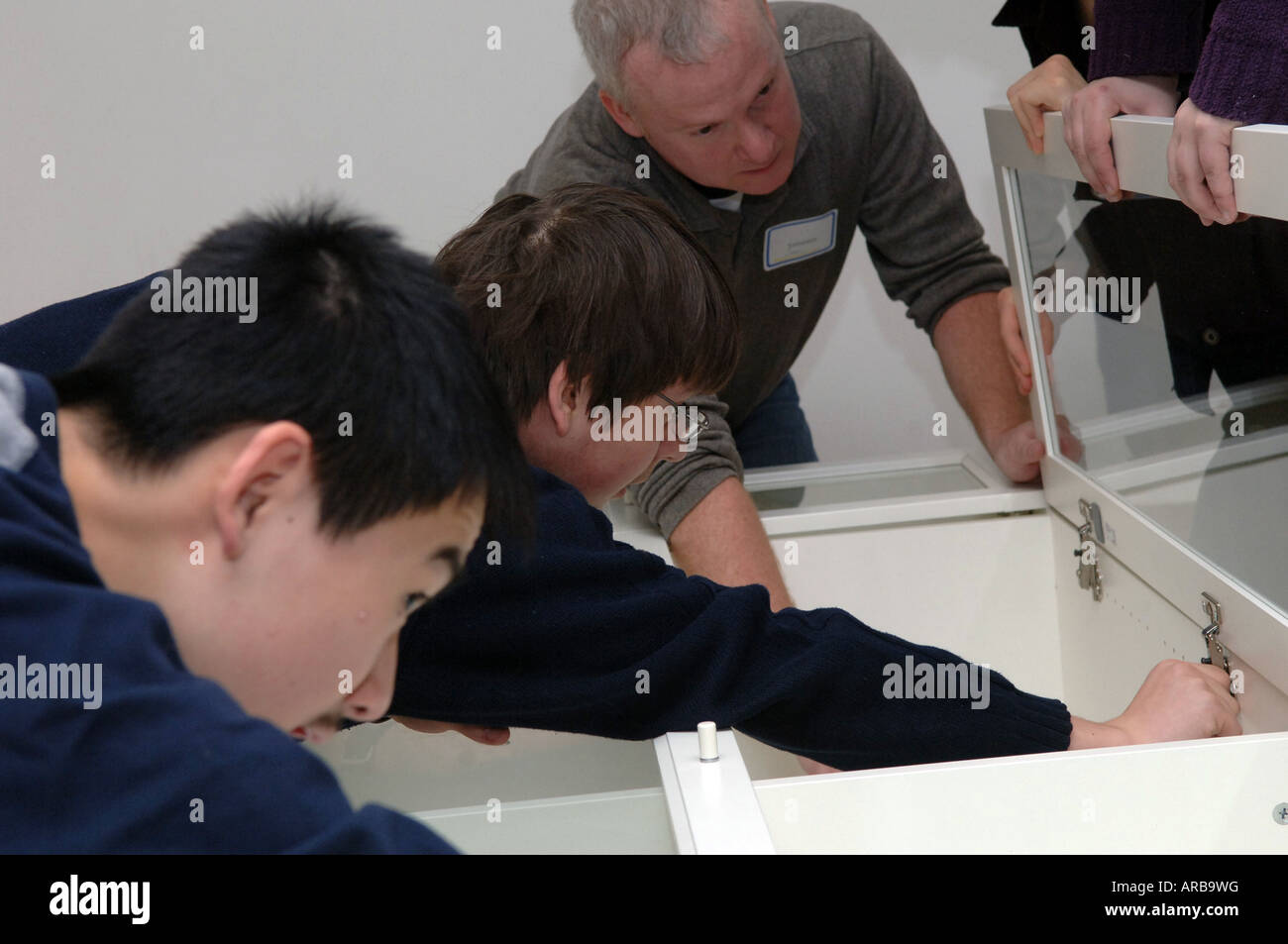 Volunteers construct bookcases for a children s library in a homeless ...