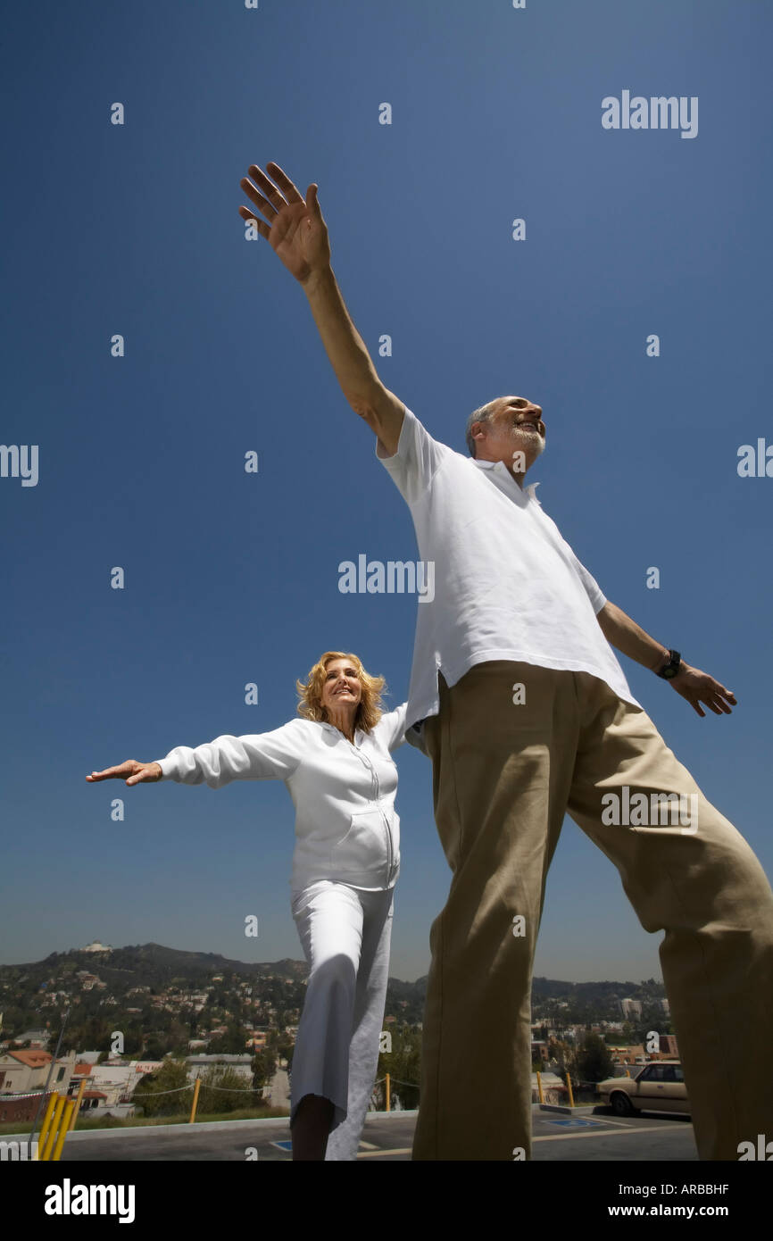Mature Couple Pretending to Fly Stock Photo - Alamy