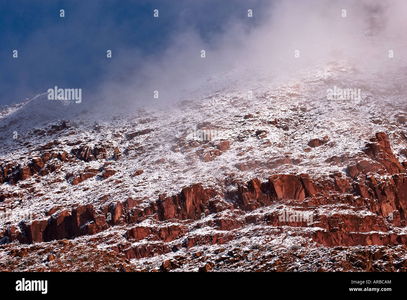 Mist and snow covered Red Mountain in Ivins, Utah. Stock Photography by ...