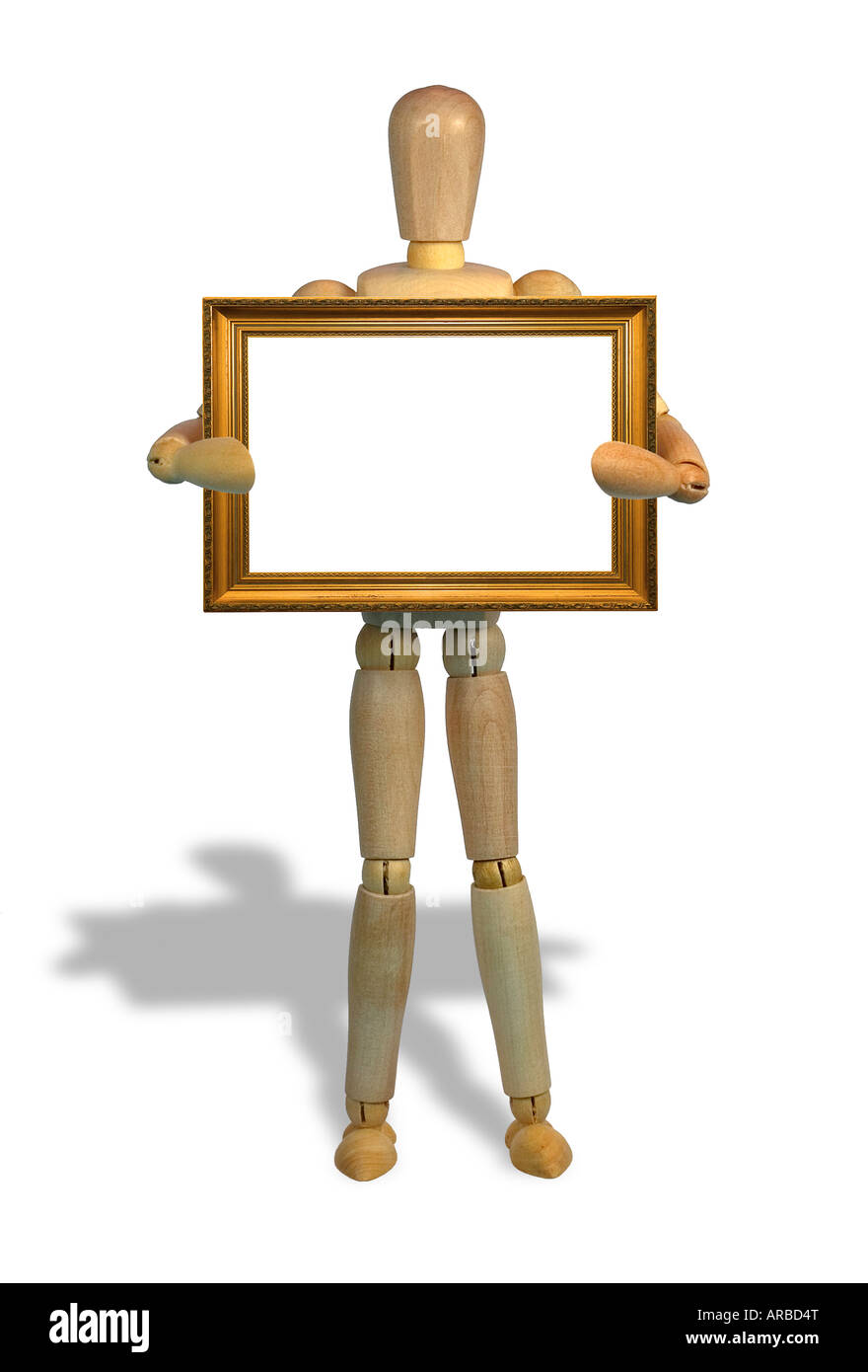 Wooden mannequin holding a gold picture frame on a white background ...
