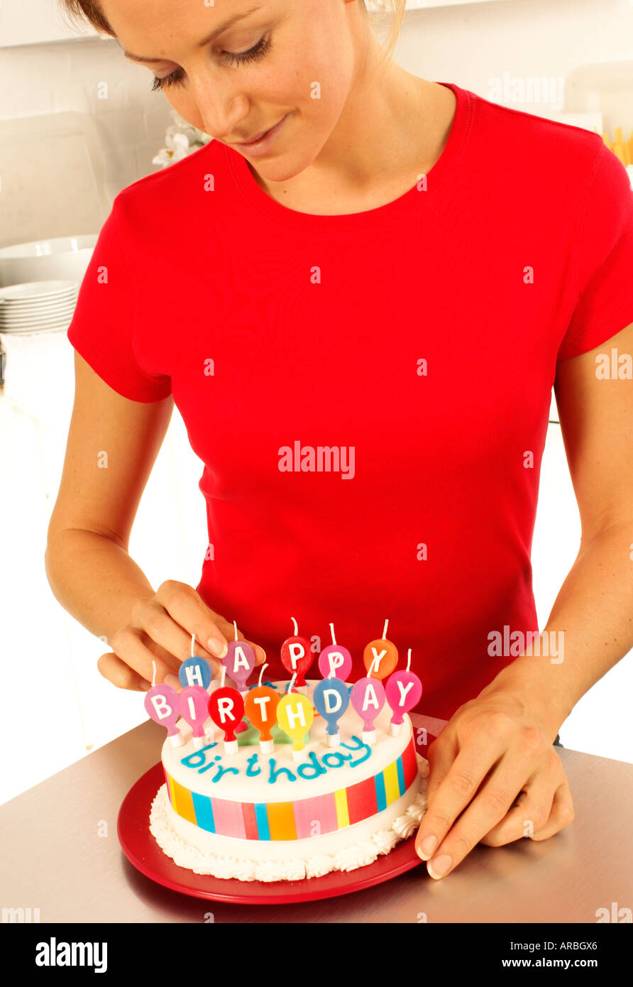 Woman icing cake hi-res stock photography and images - Alamy