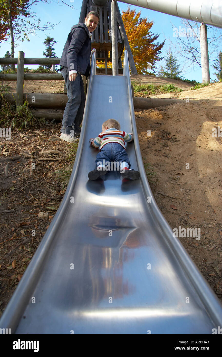 baby sliding down the slide on the playground Stock Photo - Alamy