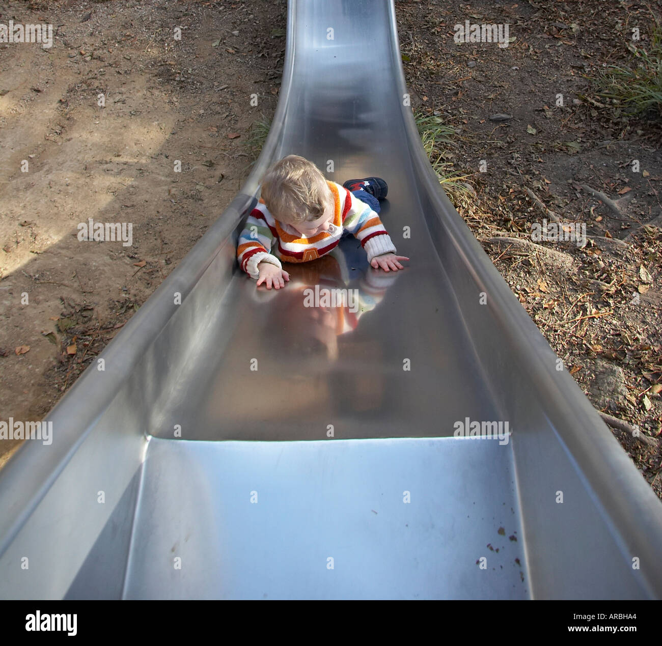baby sliding down the slide on the playground Stock Photo - Alamy