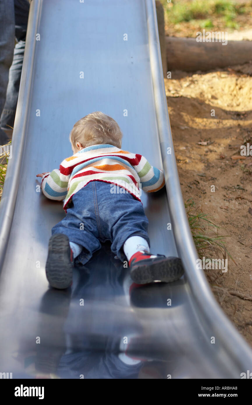 baby sliding down the slide on the playground Stock Photo - Alamy