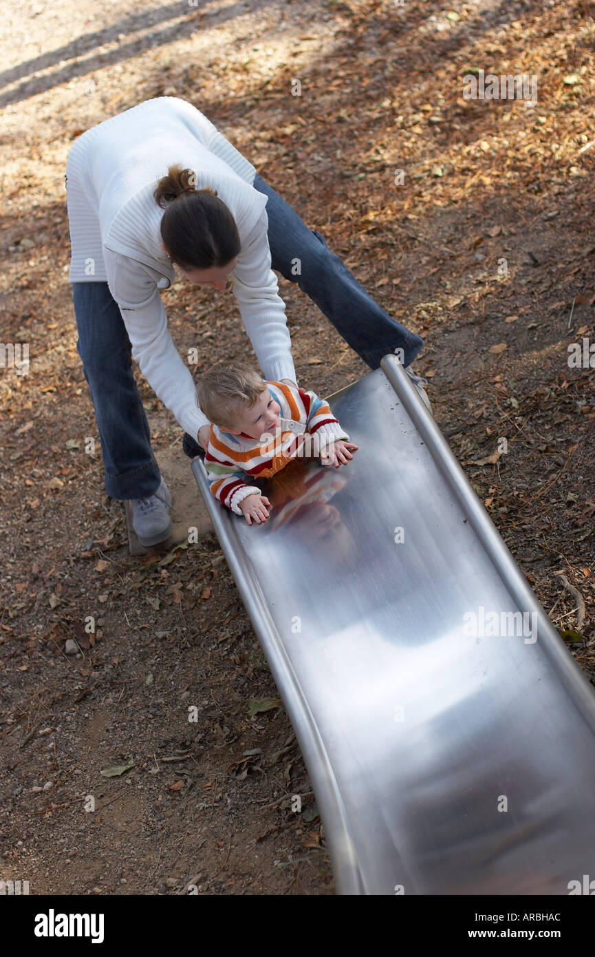 baby sliding down the slide on the playground Stock Photo - Alamy