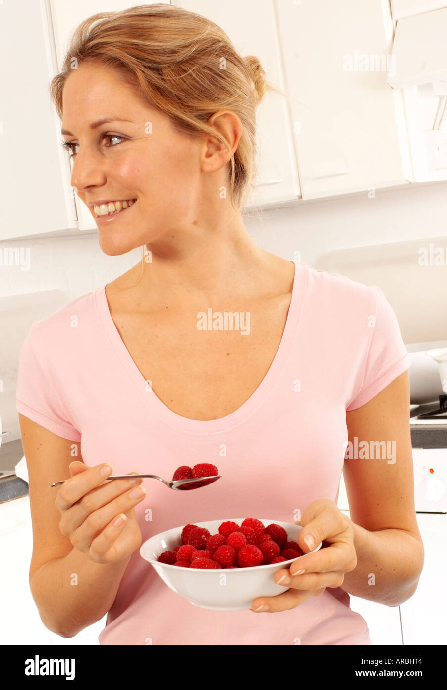 GIRL EATING RASPBERRIES Stock Photo - Alamy