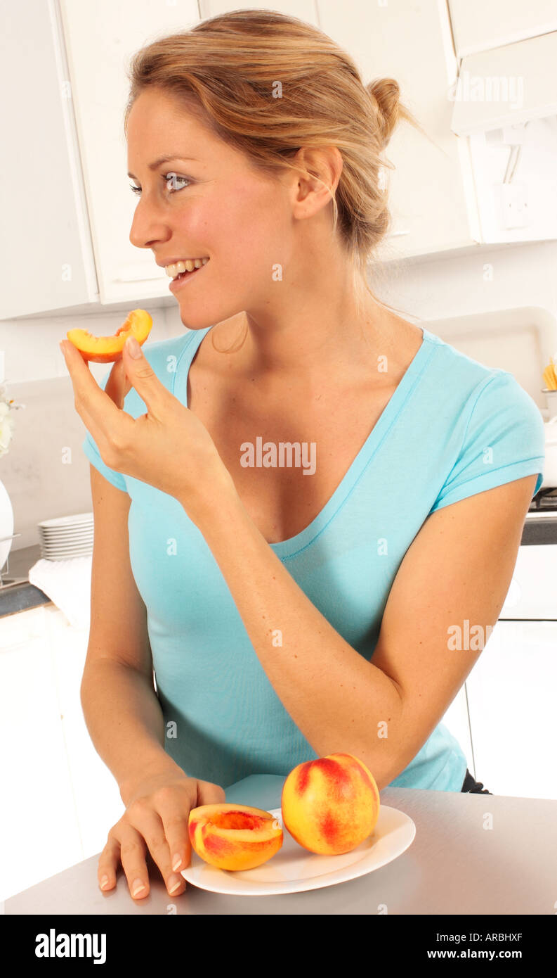 Woman eating peaches hi-res stock photography and images - Alamy