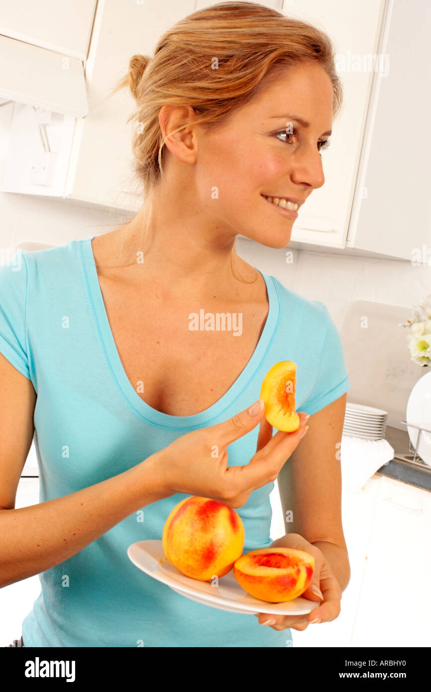 Woman eating peaches hi-res stock photography and images - Alamy